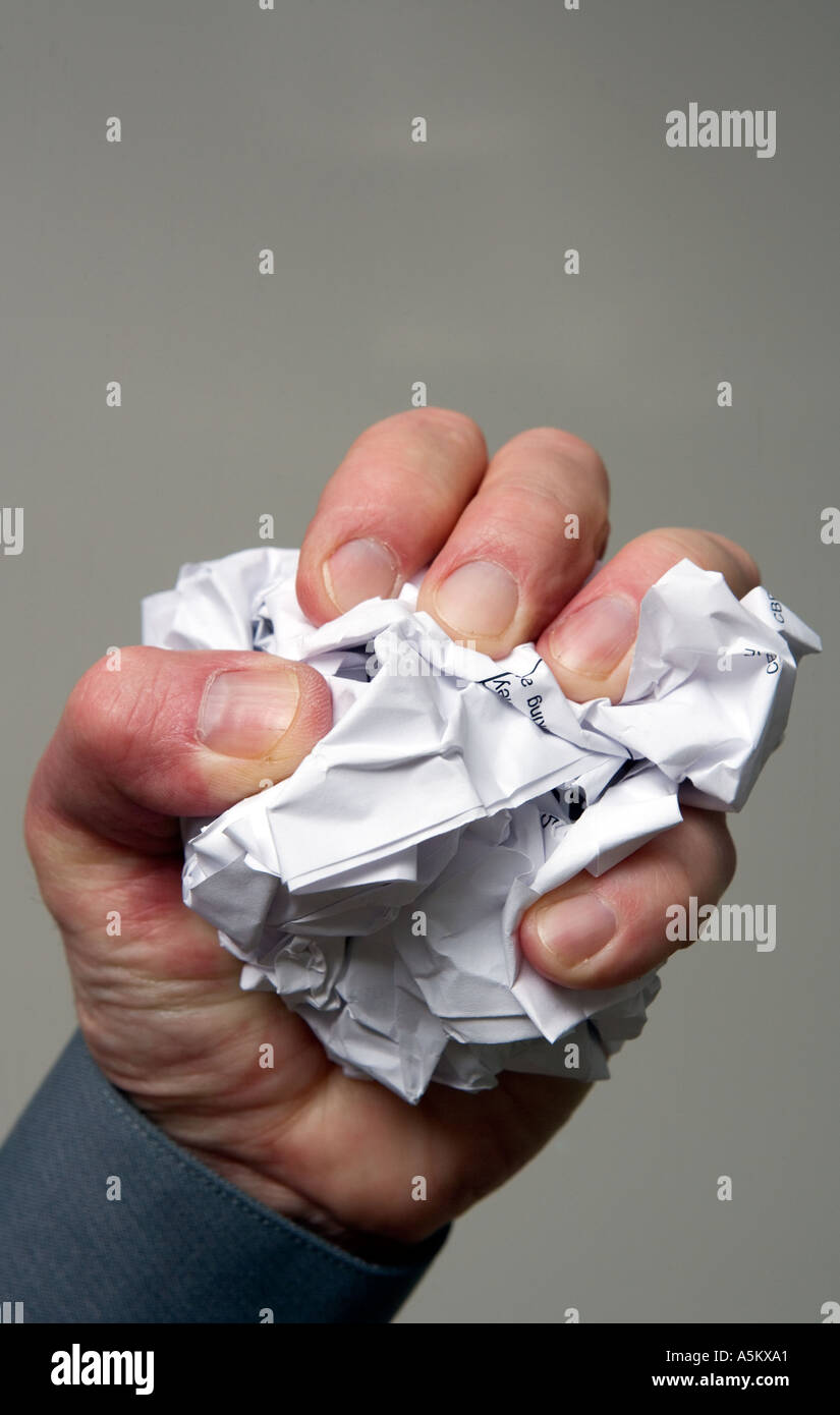 Stress office worker holds crumpled paper Stock Photo - Alamy