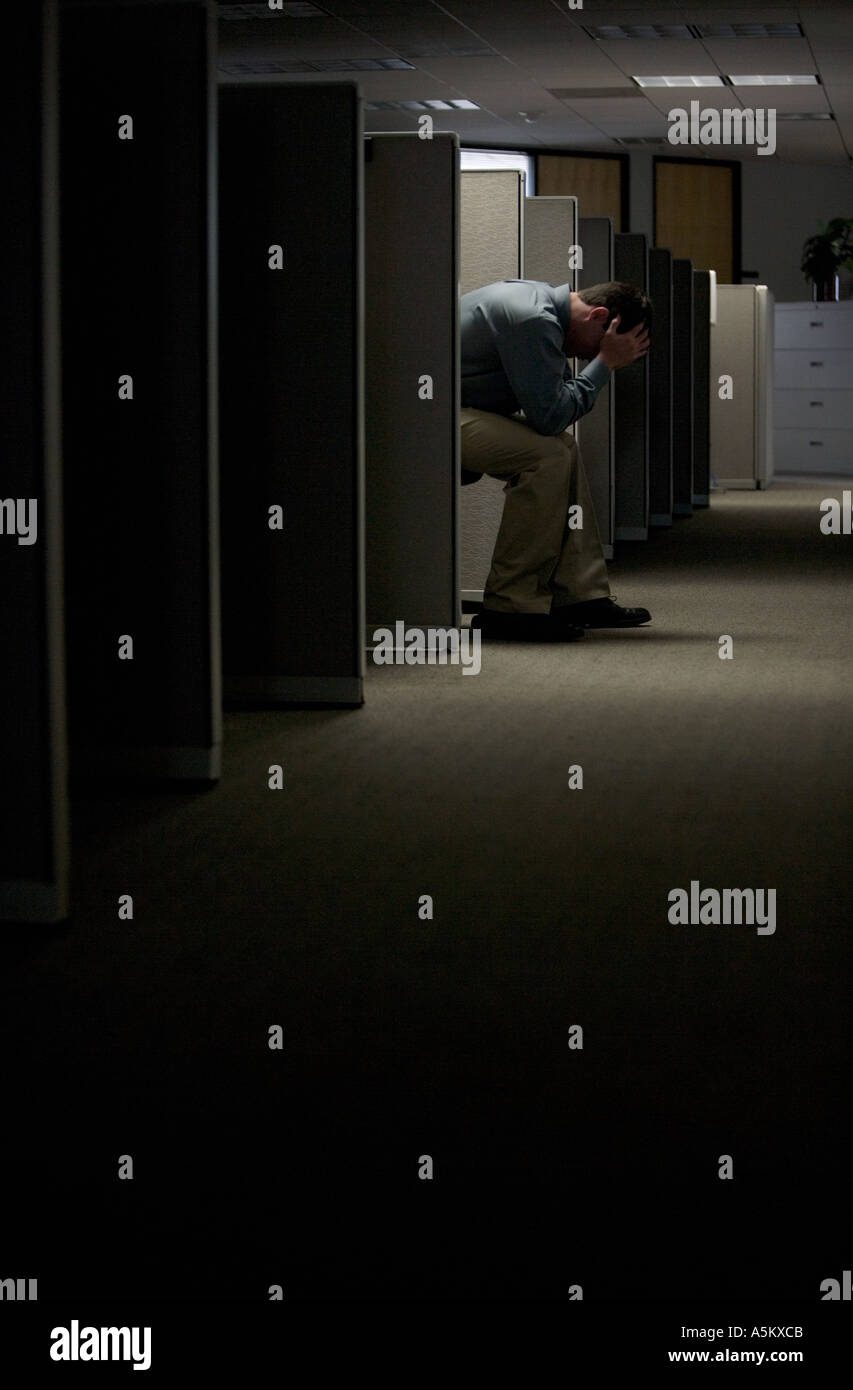 stressed out office worker with hands on head in row of cubicles Stock ...