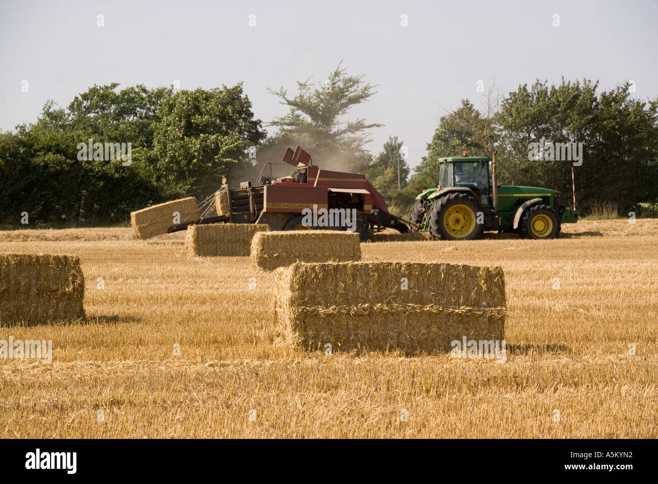 Tractor baling straw Stock Photo - Alamy