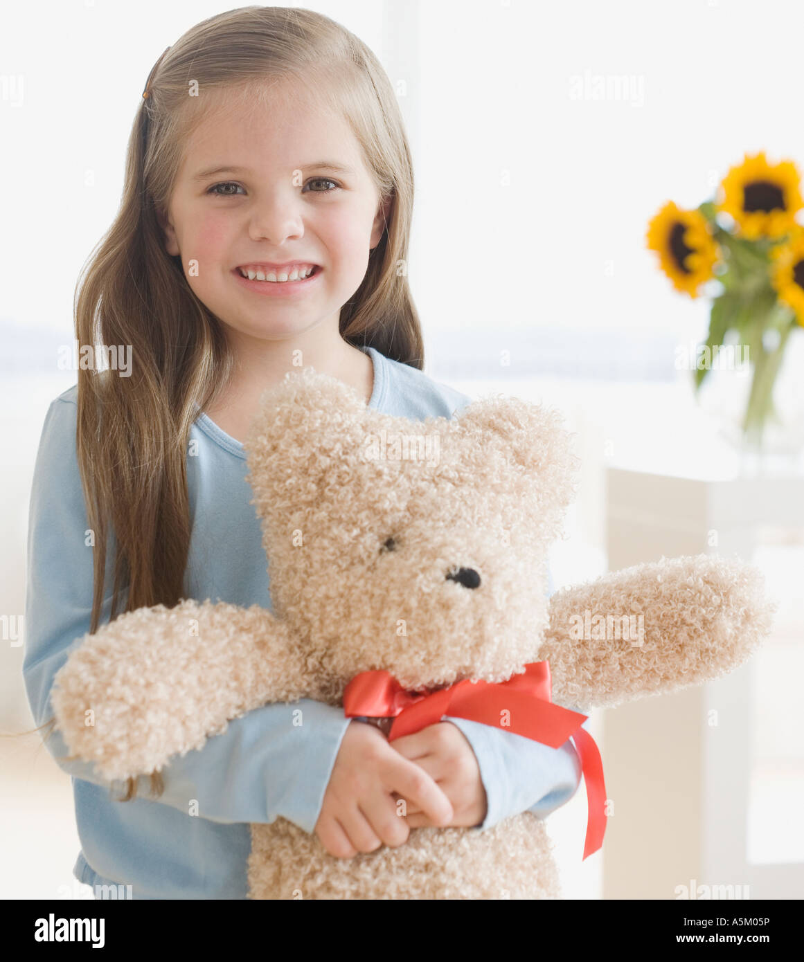 Portrait of girl hugging teddy bear Stock Photo - Alamy