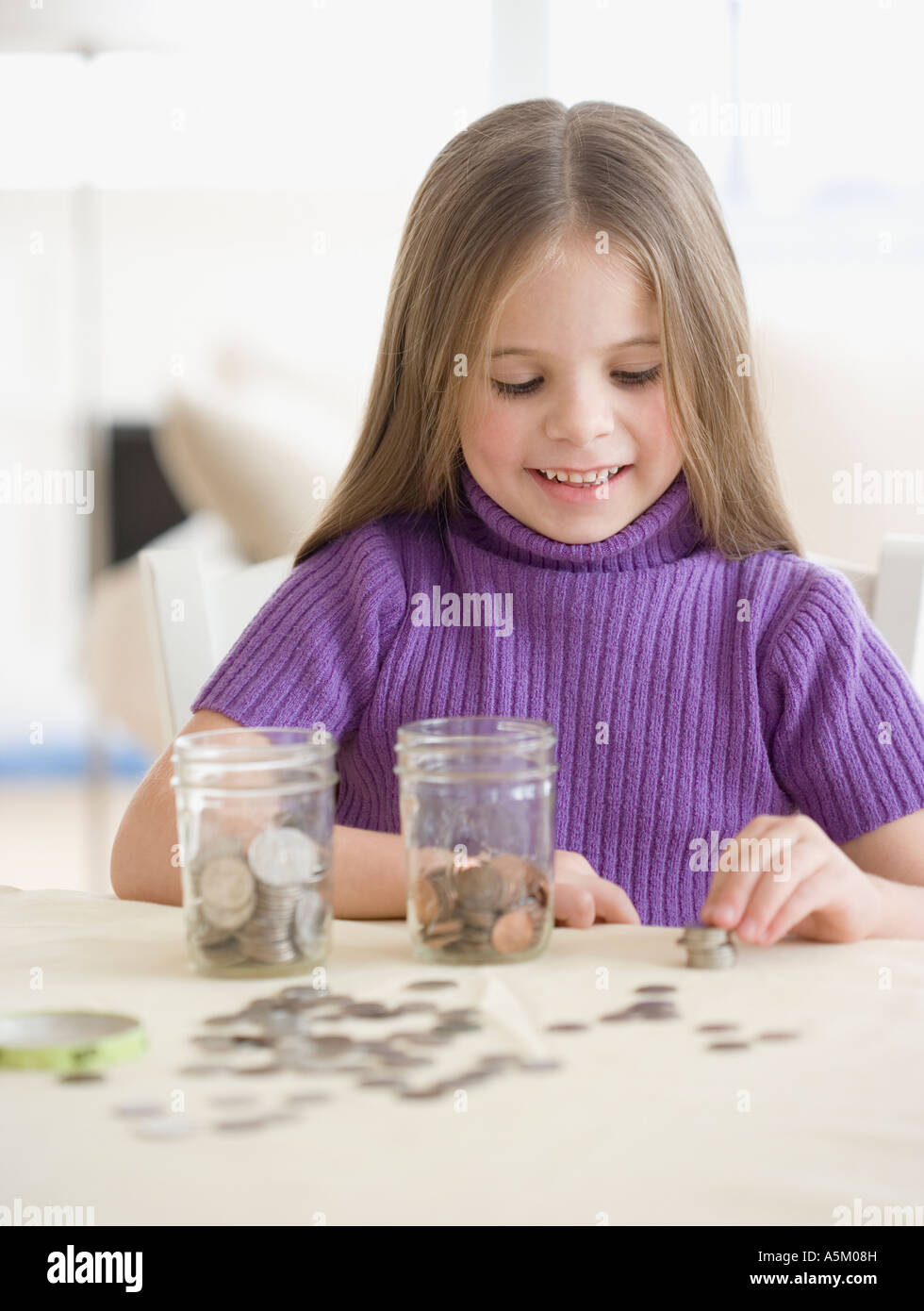 Girl counting and sorting change Stock Photo - Alamy