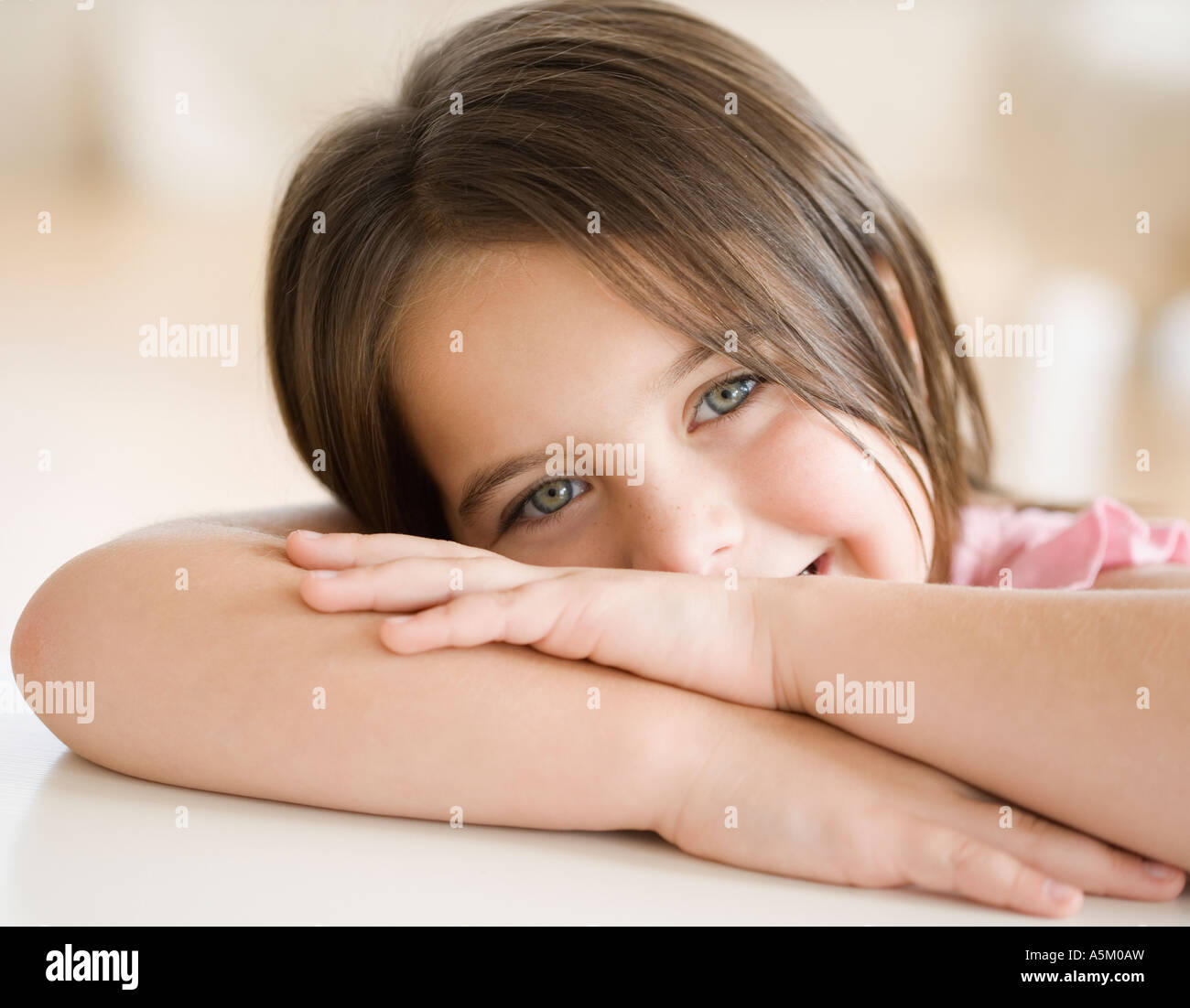 Portrait of girl leaning head on arms Stock Photo - Alamy