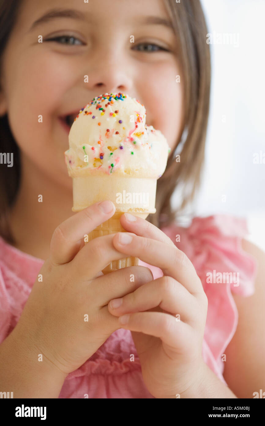 Close up of girl eating ice cream cone Stock Photo - Alamy