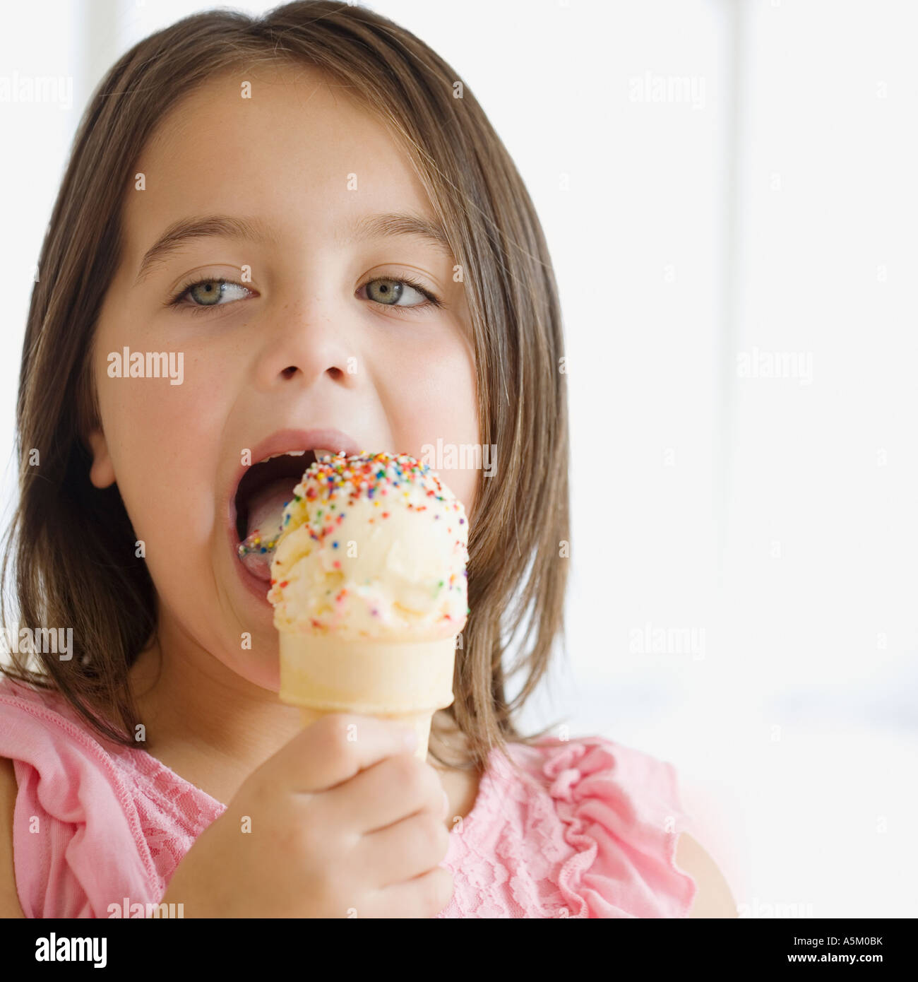 Close up of girl eating ice cream cone Stock Photo - Alamy