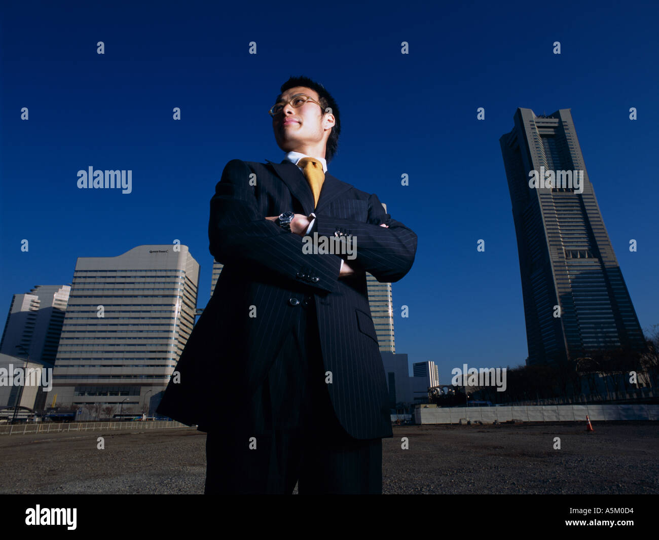 Asian Man standing in an empty parking lot Stock Photo - Alamy