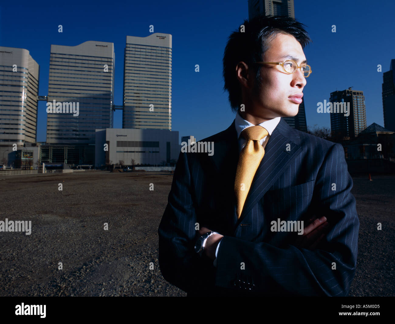 Asian Man standing in an empty parking lot Stock Photo - Alamy