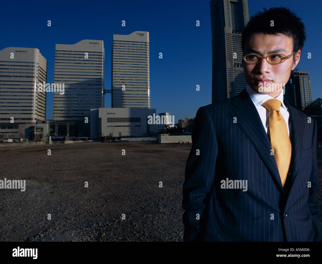 Asian Man standing in an empty parking lot Stock Photo - Alamy