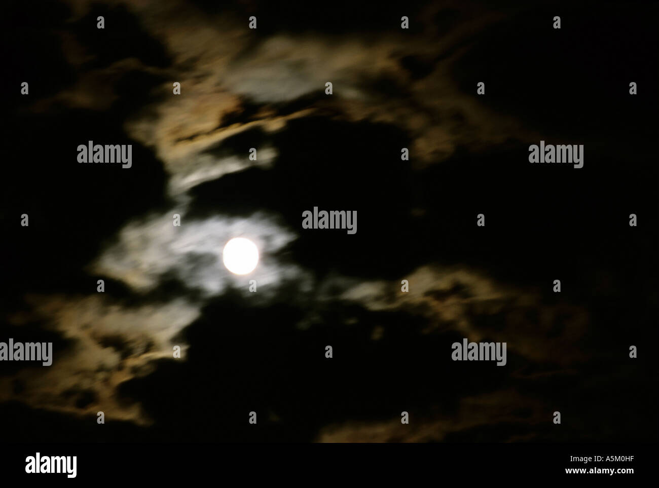 Full moon and clouds by night Stock Photo - Alamy