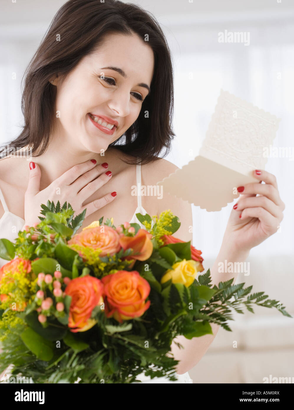 Woman reading card on flower bouquet Stock Photo - Alamy