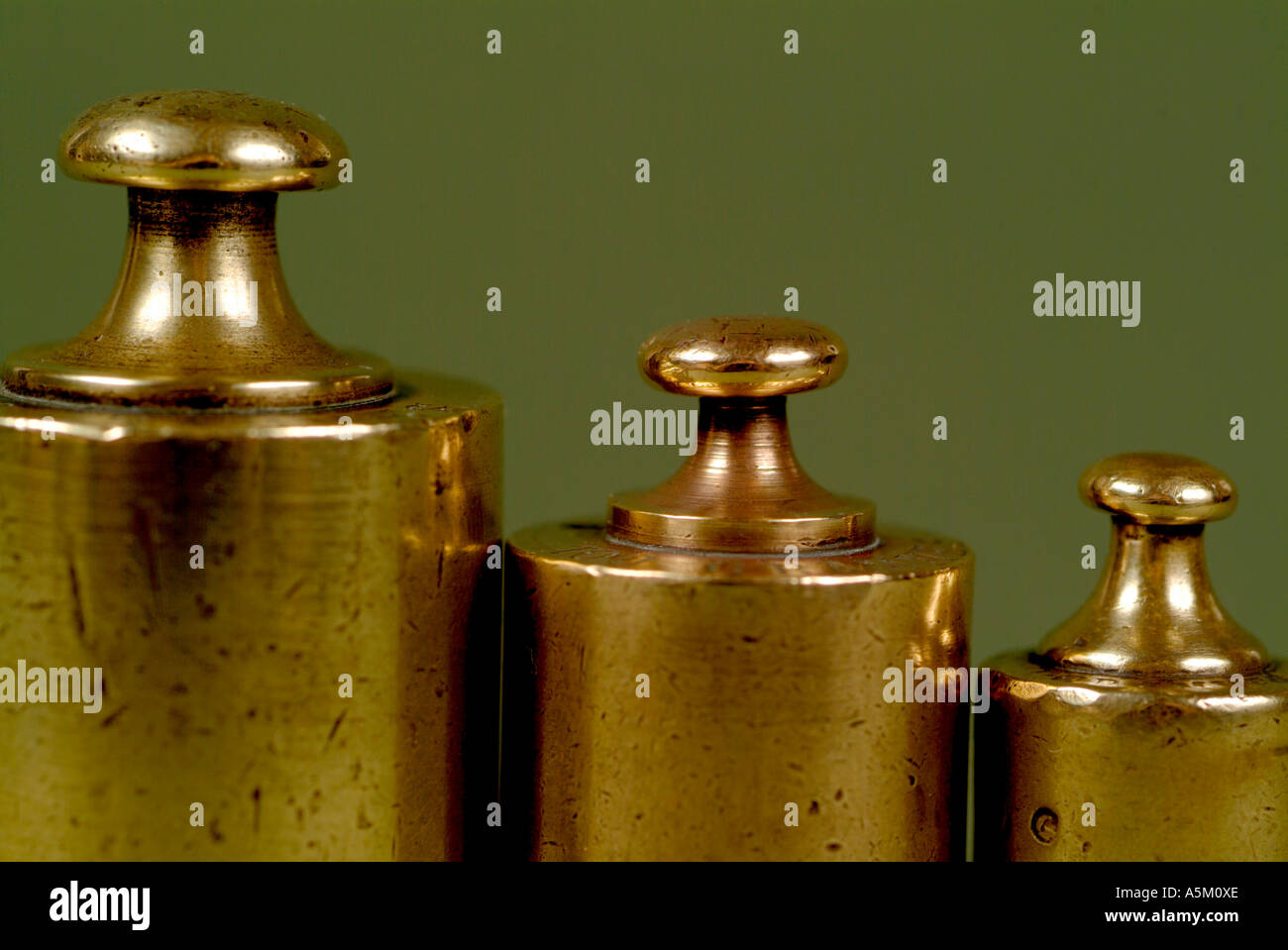 Three French copper scale weights in a row Stock Photo - Alamy