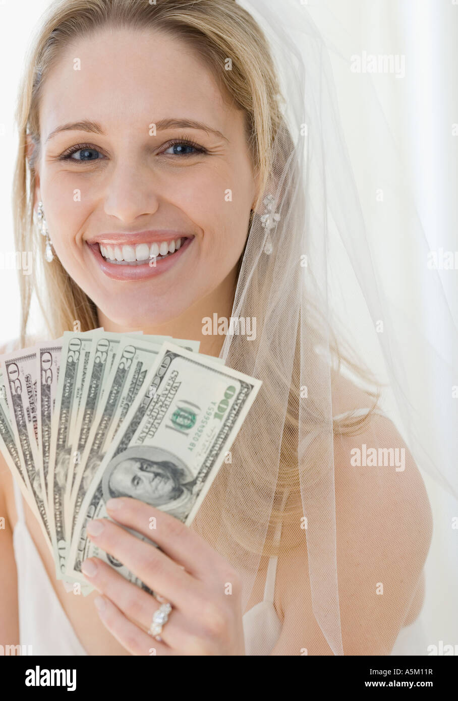 Portrait of bride holding money Stock Photo - Alamy