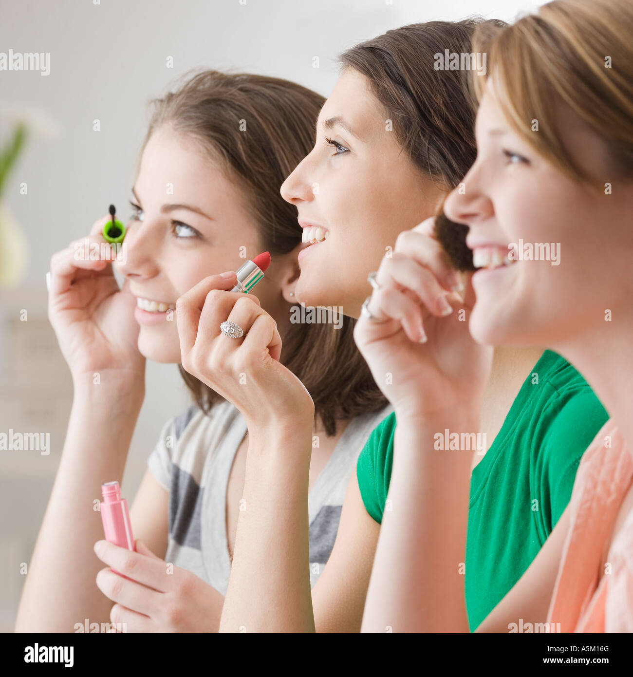 Teenage girls applying makeup Stock Photo - Alamy