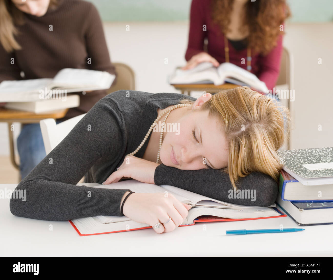 Female student sleeping on desk Stock Photo - Alamy