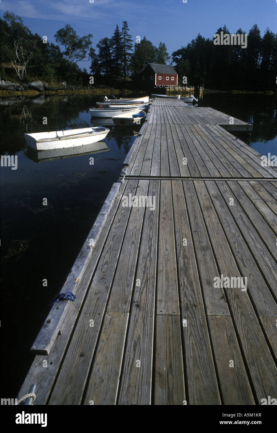 Rowboats float beside a dock in rural Maine Stock Photo - Alamy