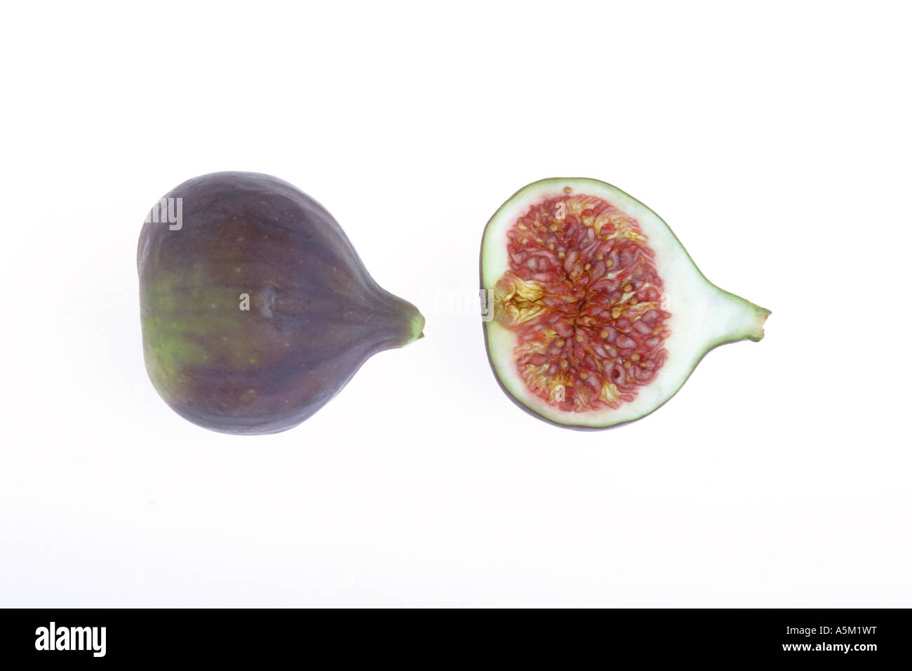 two halves of a fig on a white background Stock Photo - Alamy