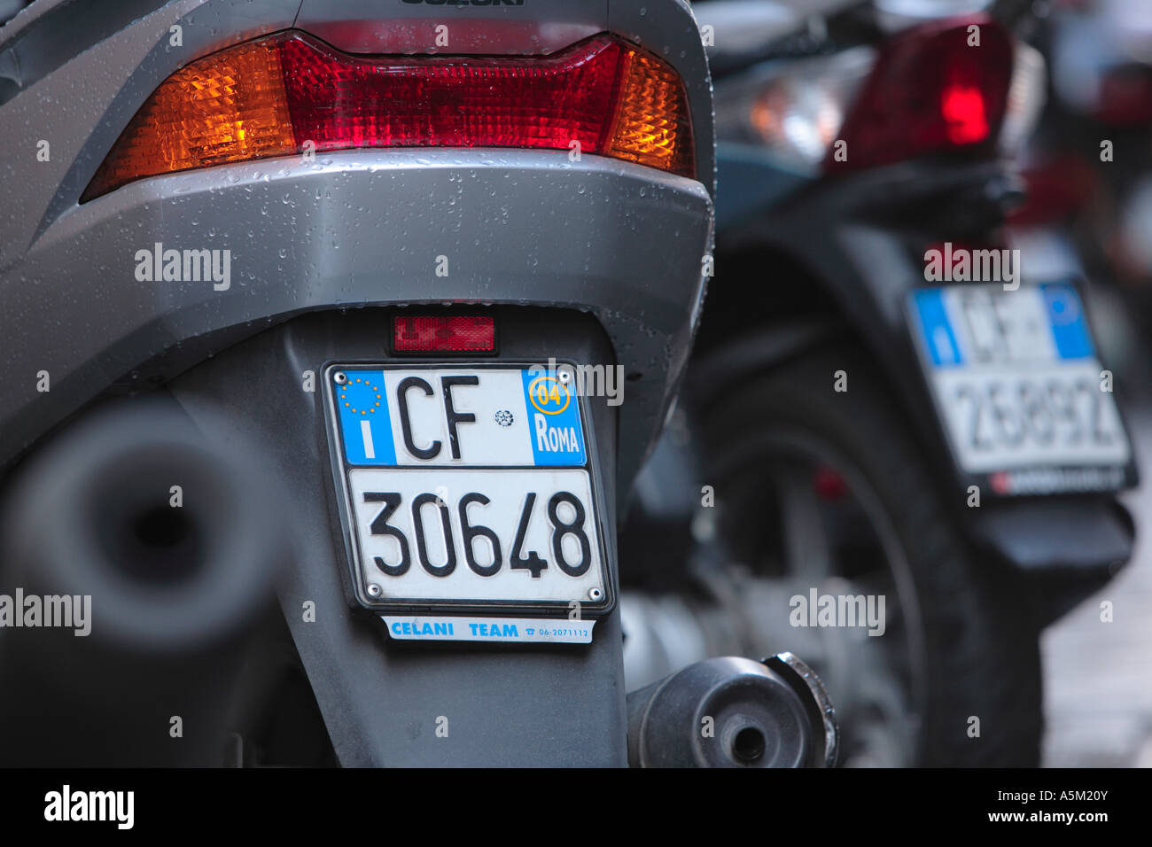 Number plates of mopeds parked in a row on a back street in Rome Italy ...
