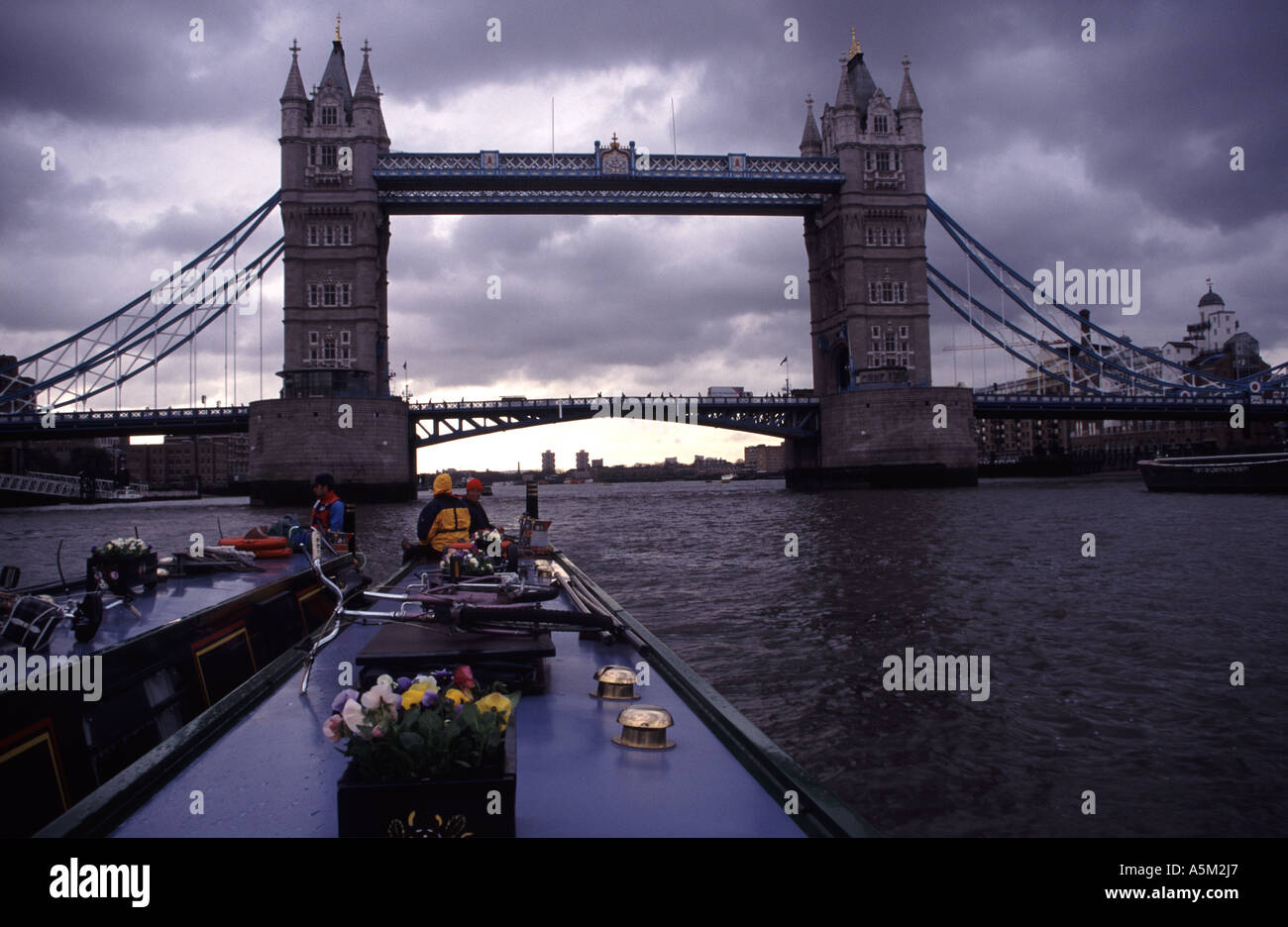 Narrowboat cruises towards Tower Bridge in London, England Stock Photo ...