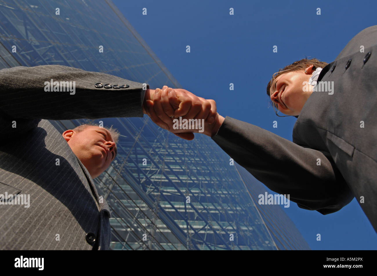 Businessmen with handshake at the Stadttor in Duesseldorf Germany Stock ...