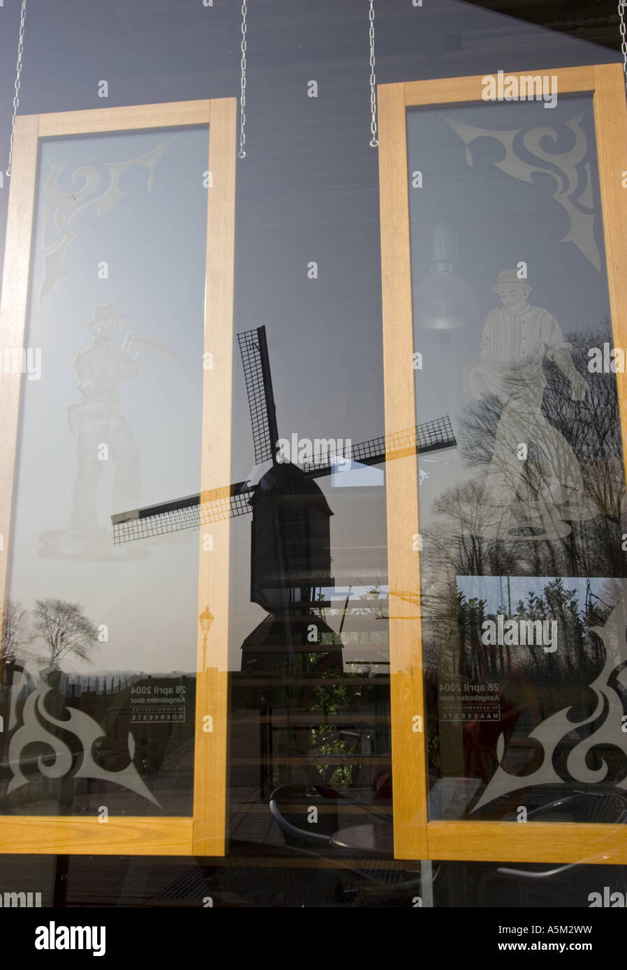 Silhouette of a windmill reflected in a shop-window Stock Photo - Alamy