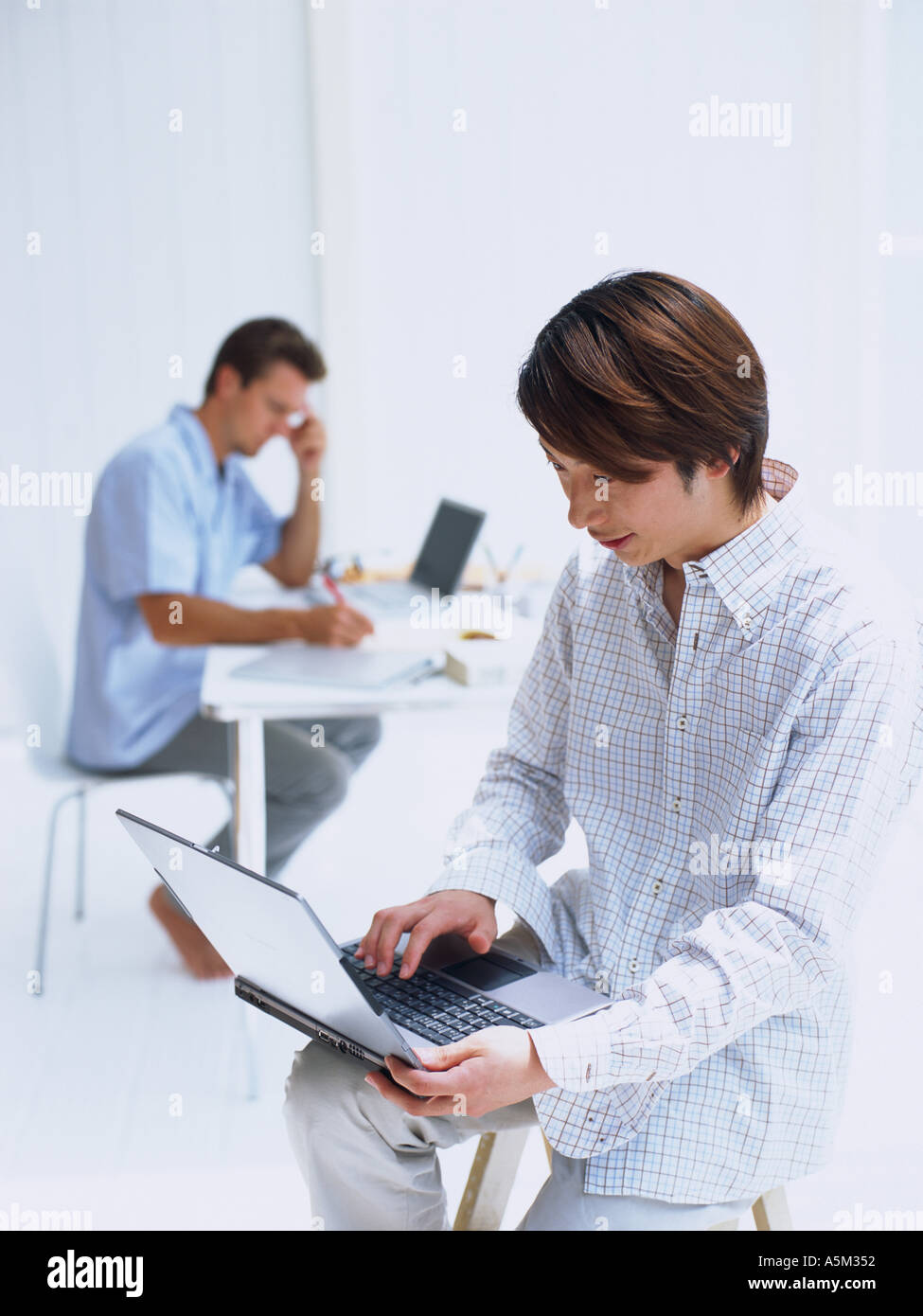 Two men working together Stock Photo - Alamy