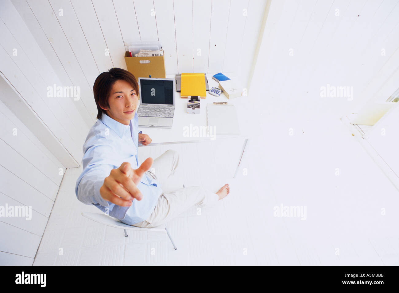 Asian man pointing up Stock Photo - Alamy