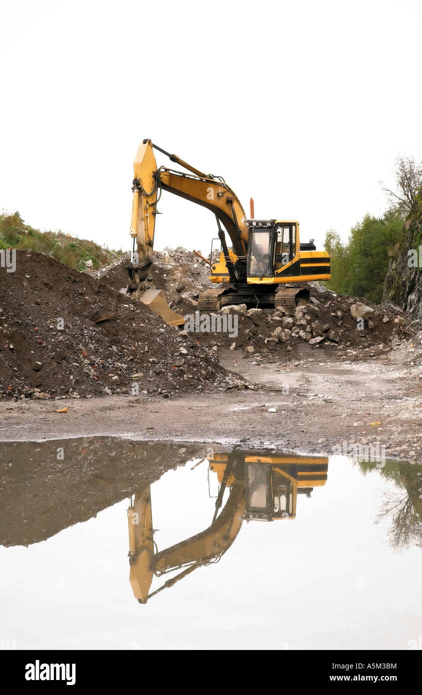 Excavator on rubble at construction site Stock Photo - Alamy