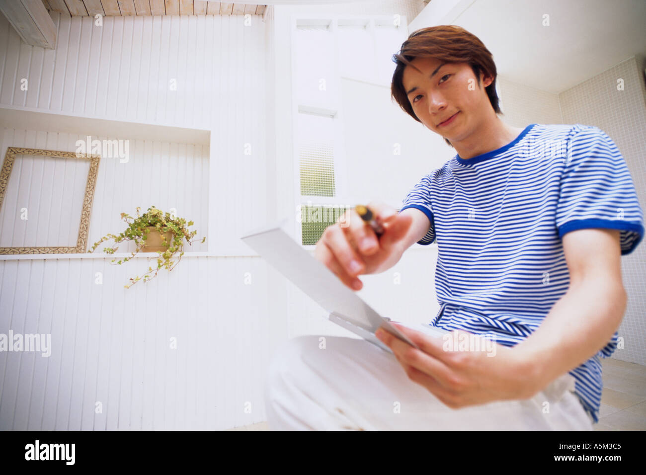 Asian man pointing a pen at the camera Stock Photo - Alamy