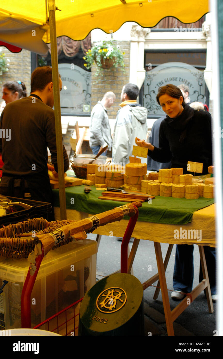 A customer samples fresh cheeses at one of the stalls Stock Photo - Alamy