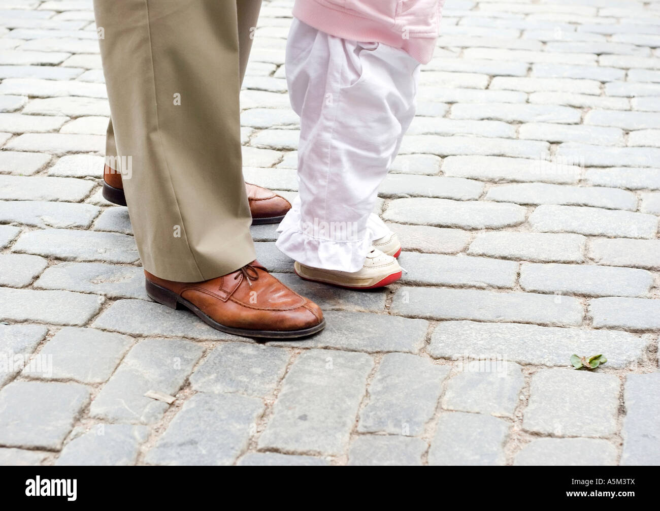 Father leading child in first steps Stock Photo - Alamy