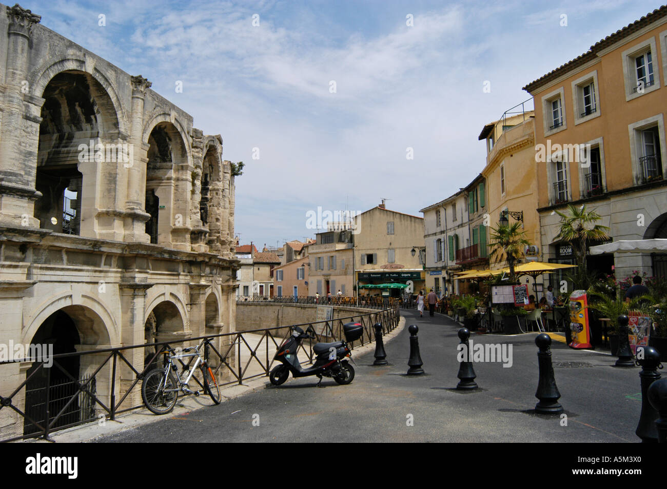 A scenic downtown street in Old Arles overlooks remains of the ancient ...