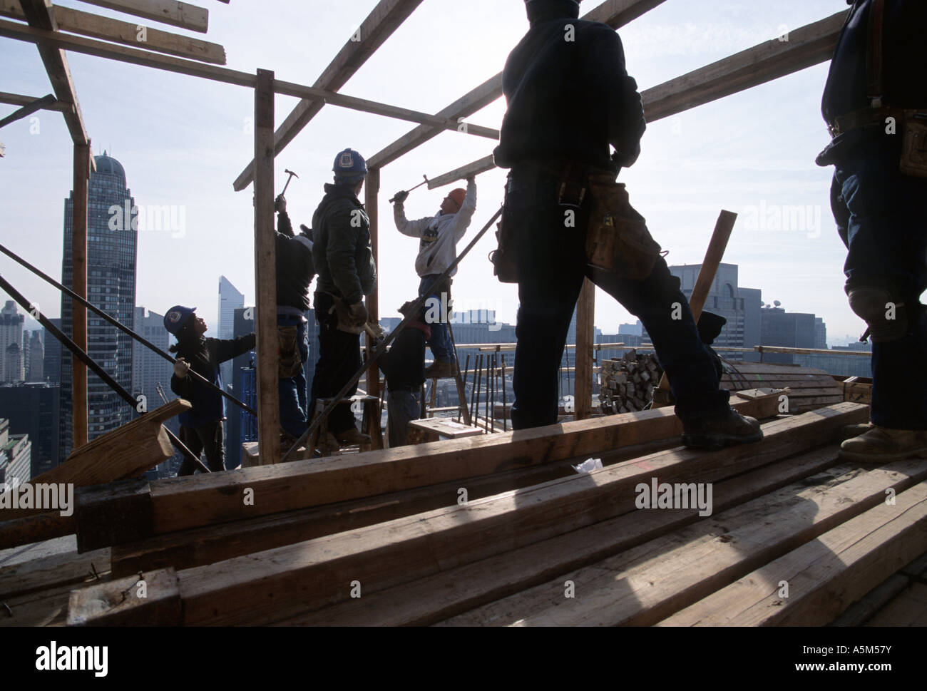 Carpenters build frame for floors in reinforced concrete construction ...