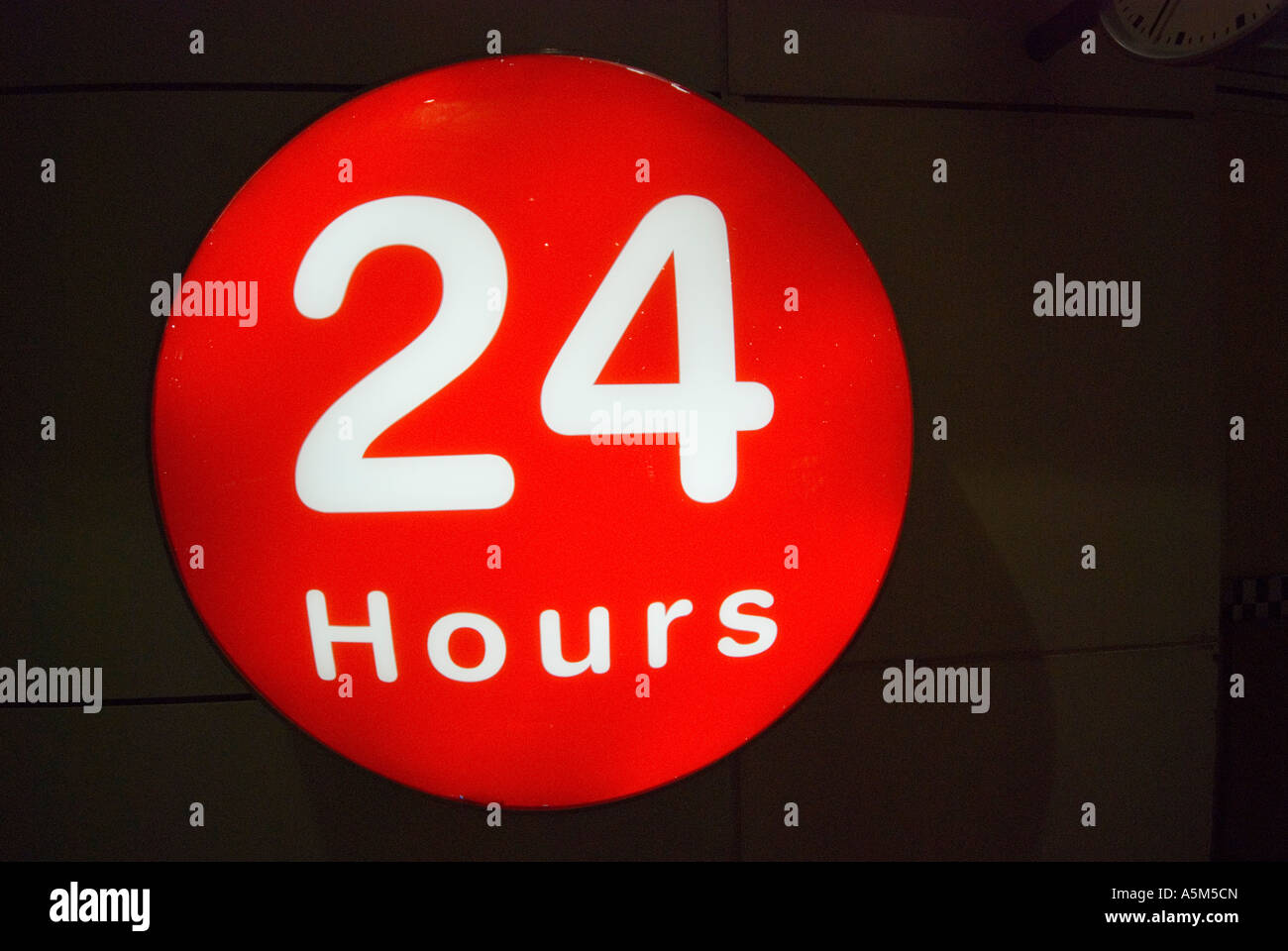 Illuminated 24 hour sign Stock Photo - Alamy