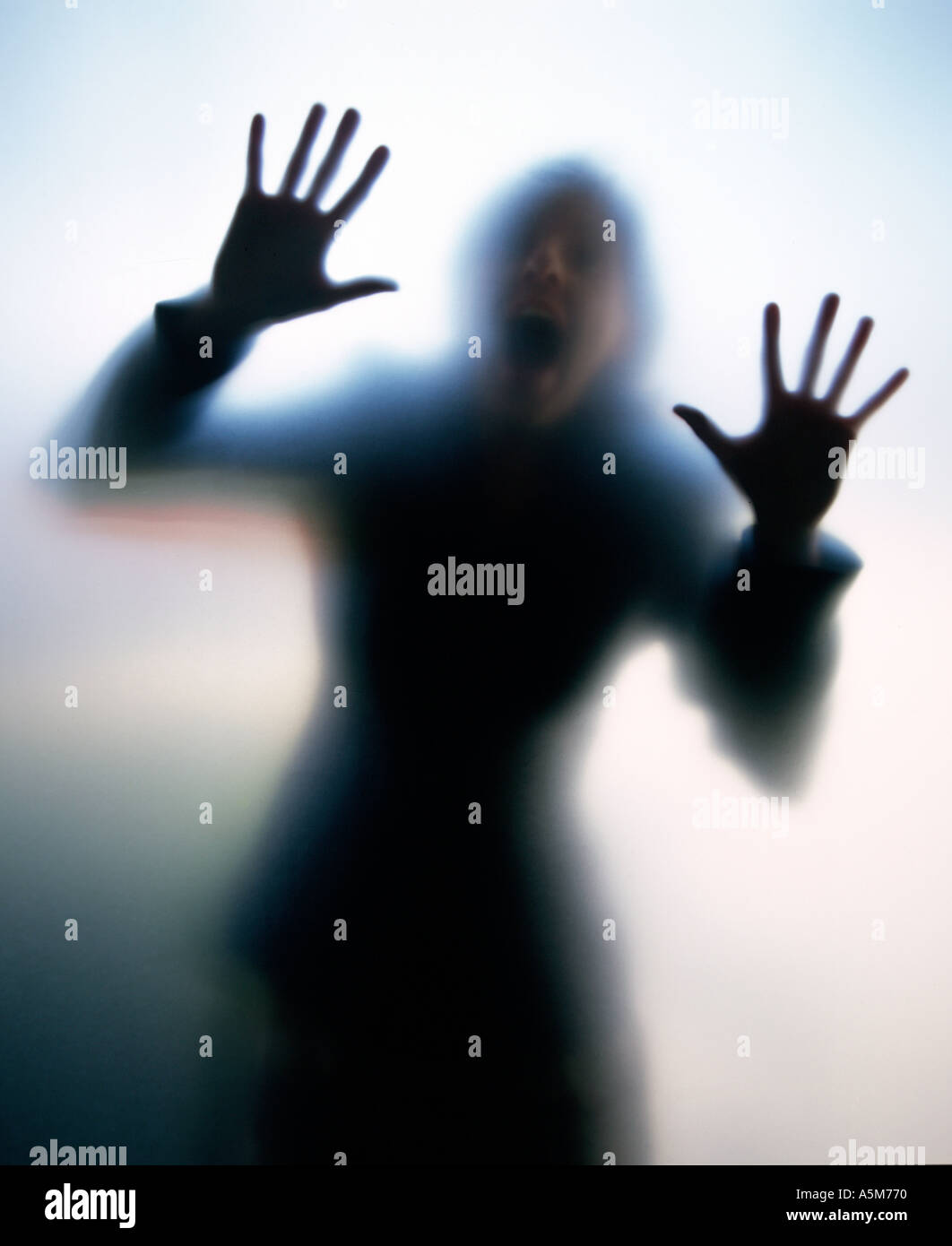 Screaming lady with hands on frosted glass window in corporate office ...