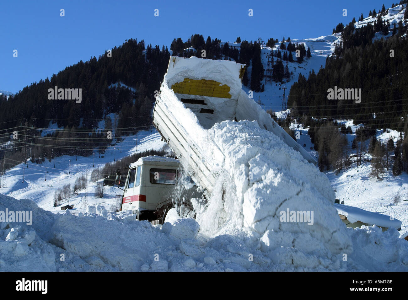 Lorry tipping snow taken off roads. St Anton Austria Stock Photo - Alamy