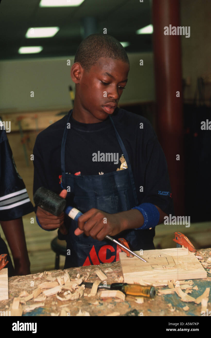 Freshman student works in the wood shop at a Detroit Michigan inner ...