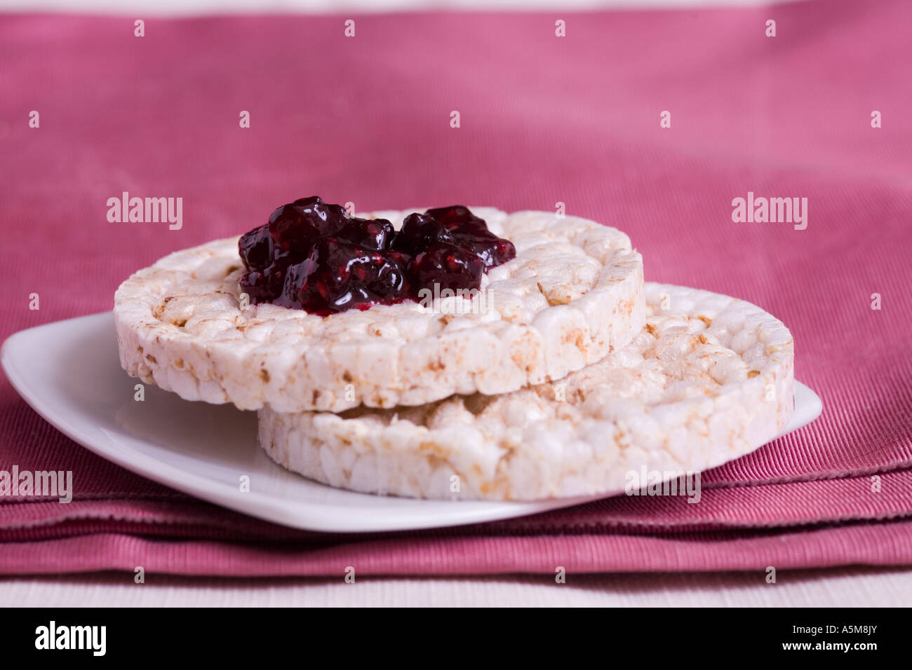 Rice bread disks with jam Stock Photo - Alamy