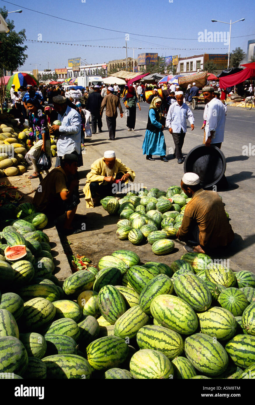 Melon sellers at Sunday bazaar on the Silk Road in Khotan, Xinjiang ...