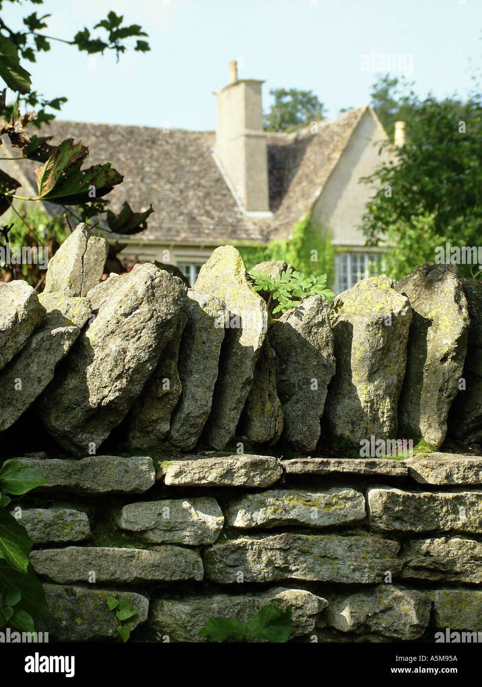 View over Stone wall to house, Minster lovel Stock Photo - Alamy