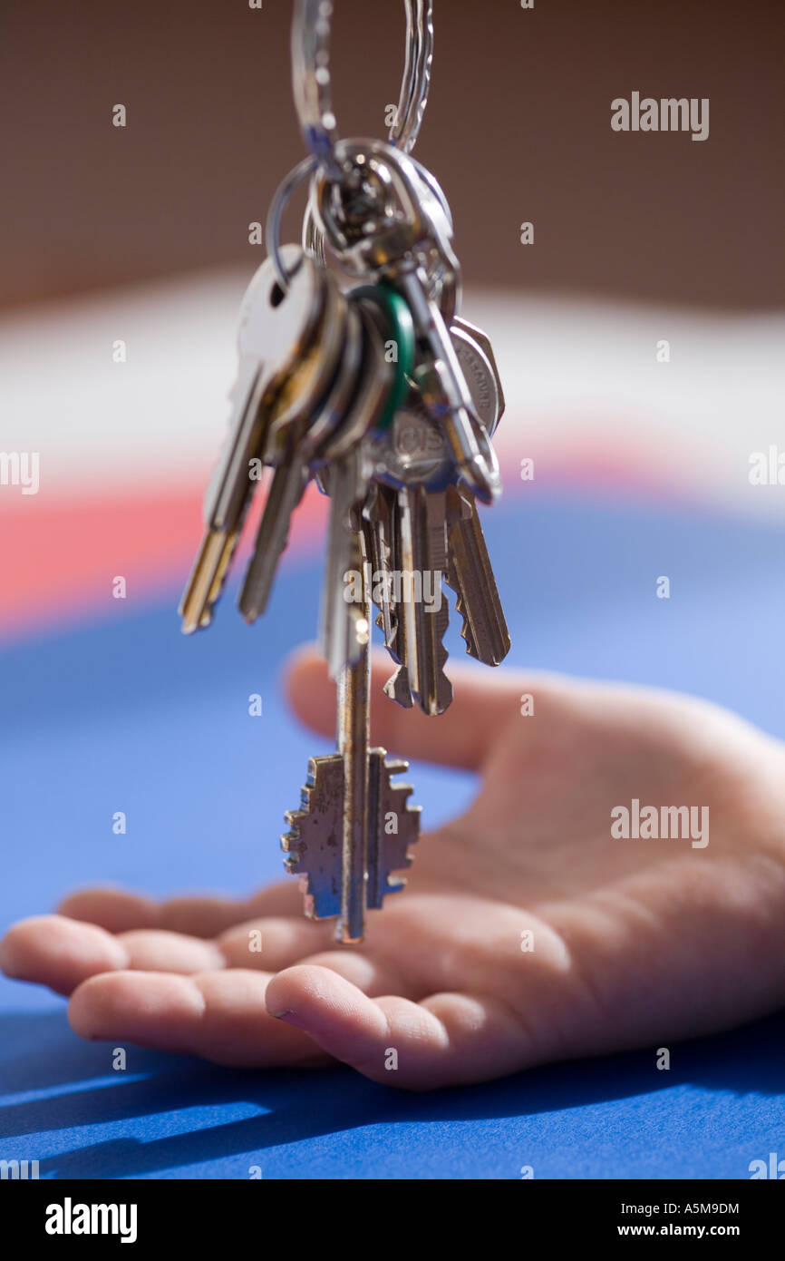 Child's hand receiving house key Stock Photo - Alamy