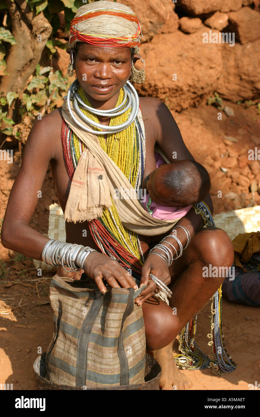 primitive Bondo (Bonda) tribal woman and baby resting on way to weekly ...