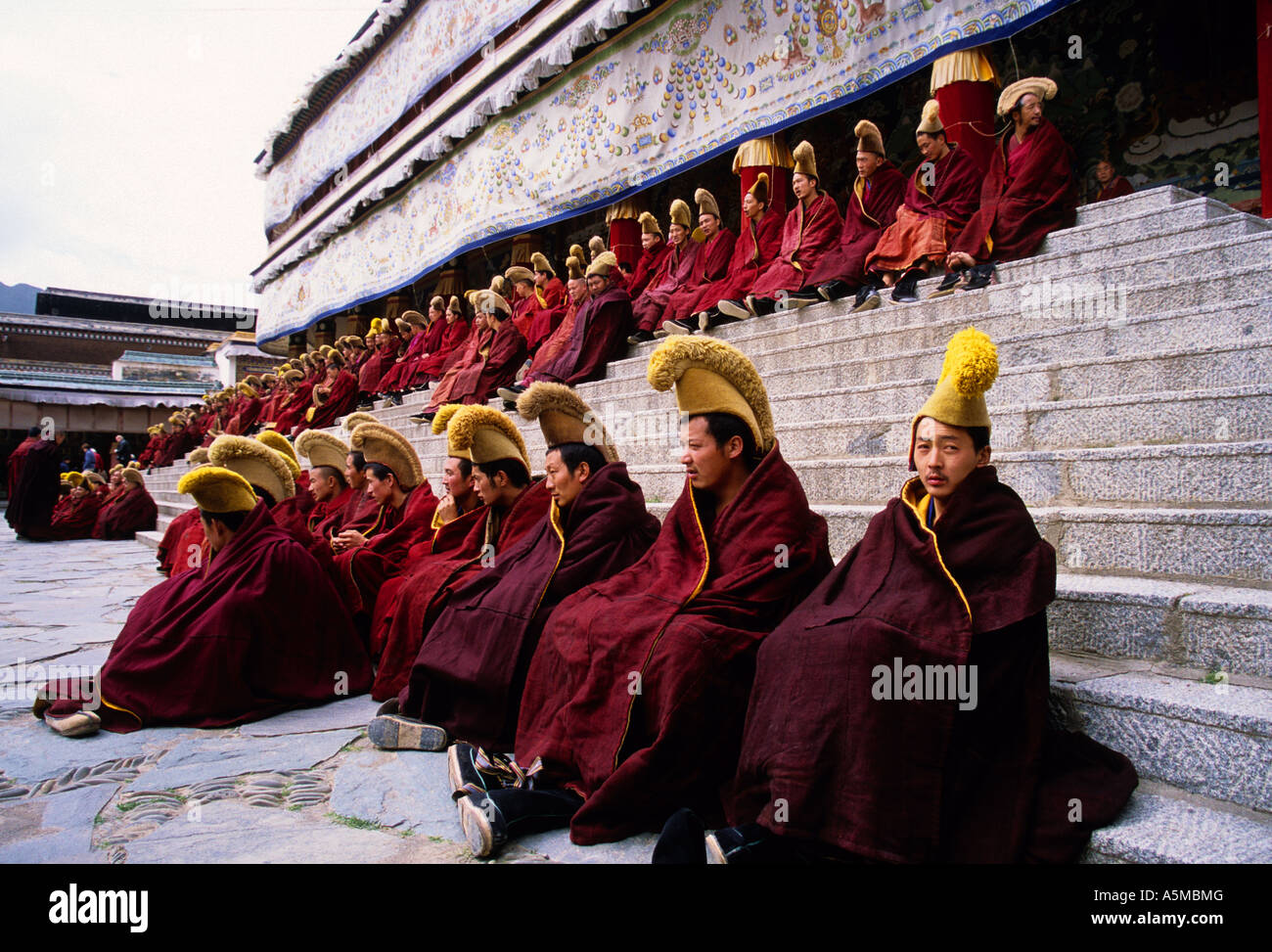 Tibetan monks of the Yellow Hat Sect on steps of Labrang monastery in ...