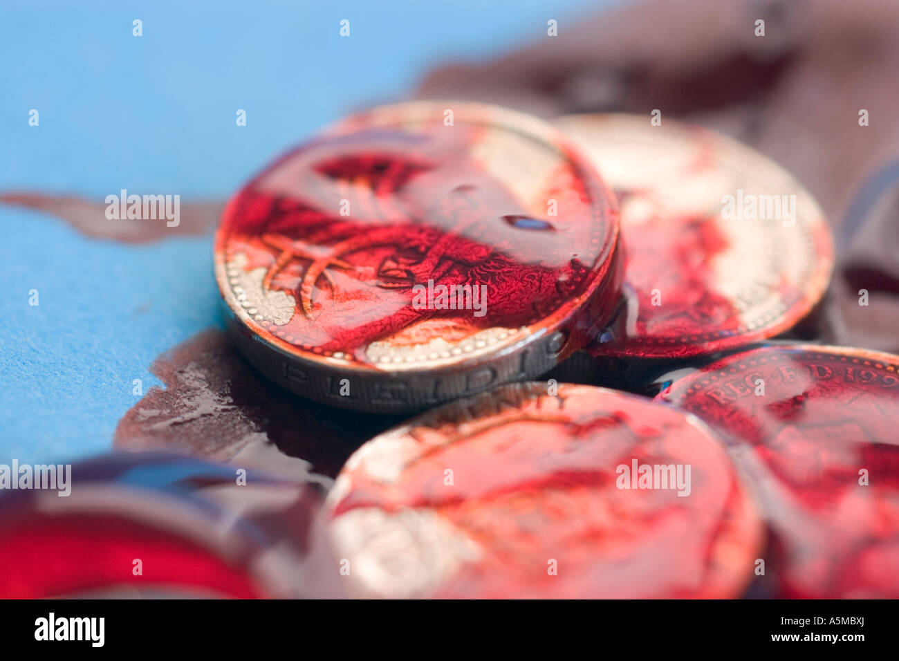 blood money cash sterling coins smeared with blood Stock Photo - Alamy