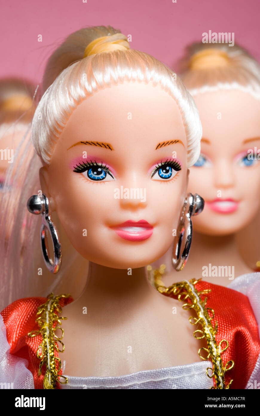 dolls face ,head and shoulders close up pink background Stock Photo - Alamy