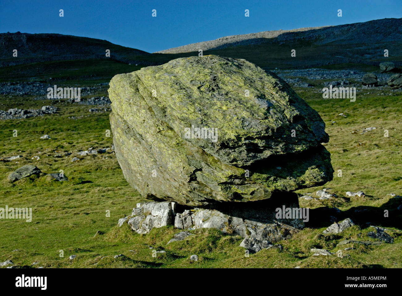Perched erratic granite boulder on limestone pedestal. Norber ...