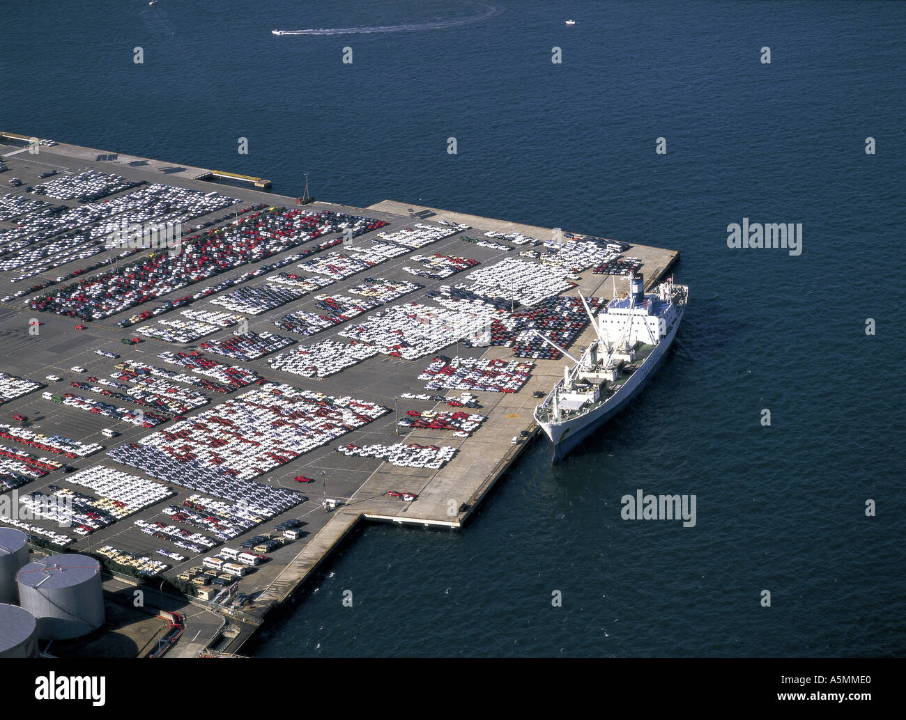 Aerial view of cars being loaded on ship for export from Yokohama Japan ...