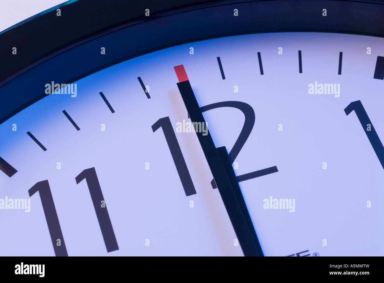 a black wall clock with a white face shows 12 o clock Stock Photo - Alamy