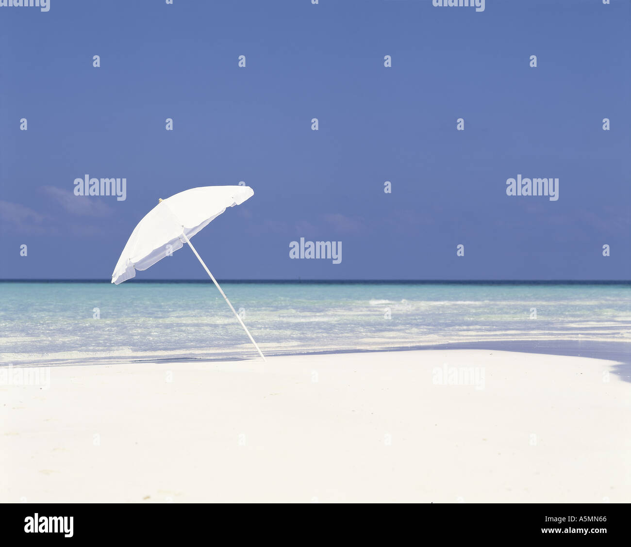White parasol on beach Maldives Stock Photo - Alamy