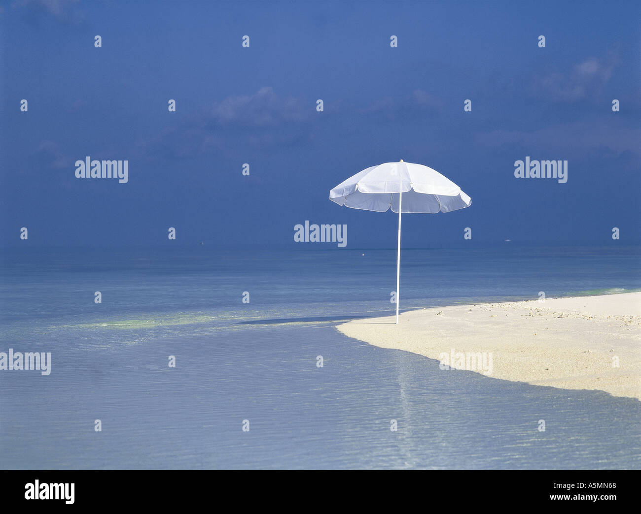 White parasol on beach Maldives Stock Photo - Alamy