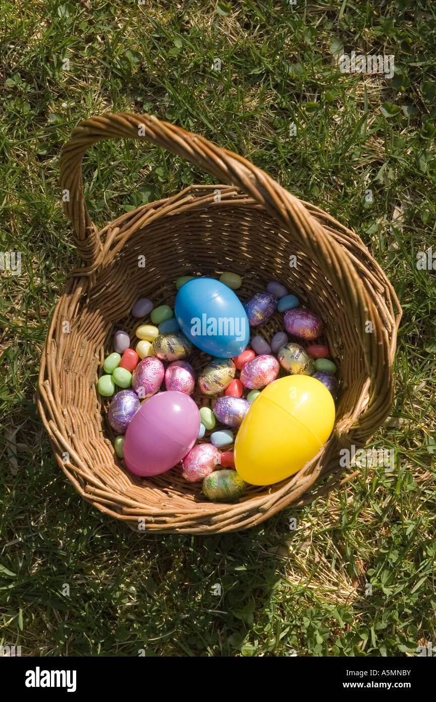 a basket filled with plastic easter eggs and egg shaped chocolate candy ...