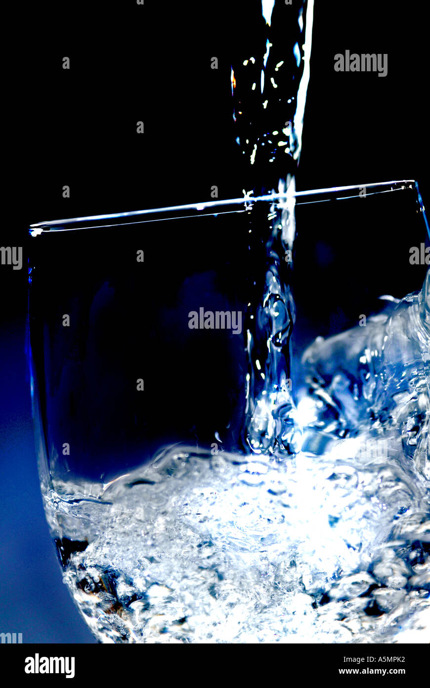 Water flowing in a glass Stock Photo - Alamy
